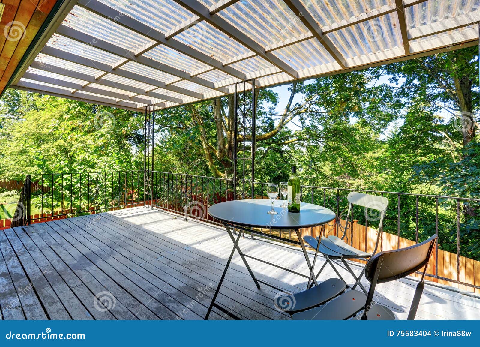 Covered Walkout Deck with Metal Railings and Table Set. Stock Photo ...