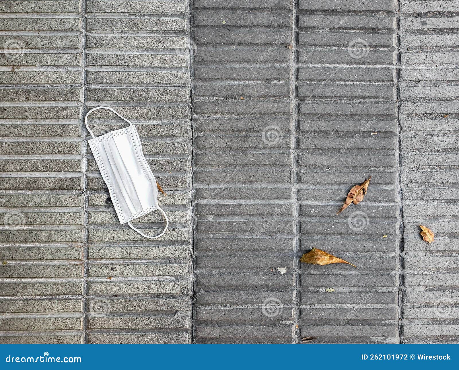 Covid Mask on Thin Slates of Bricks on a Paved Stone Background Stock ...