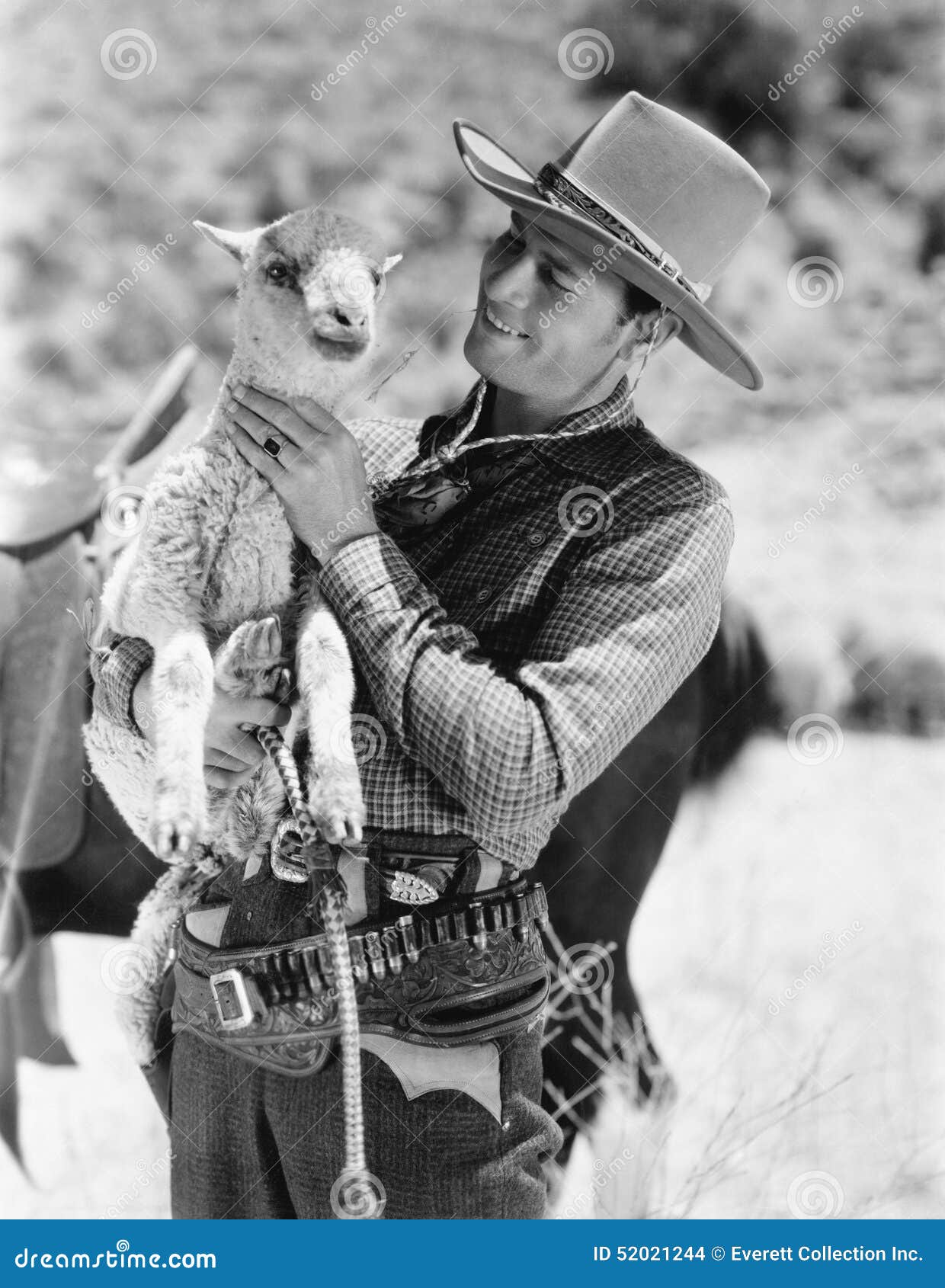 Cowboy Carrying a Lamb and Smiling Stock Photo - Image of black ...