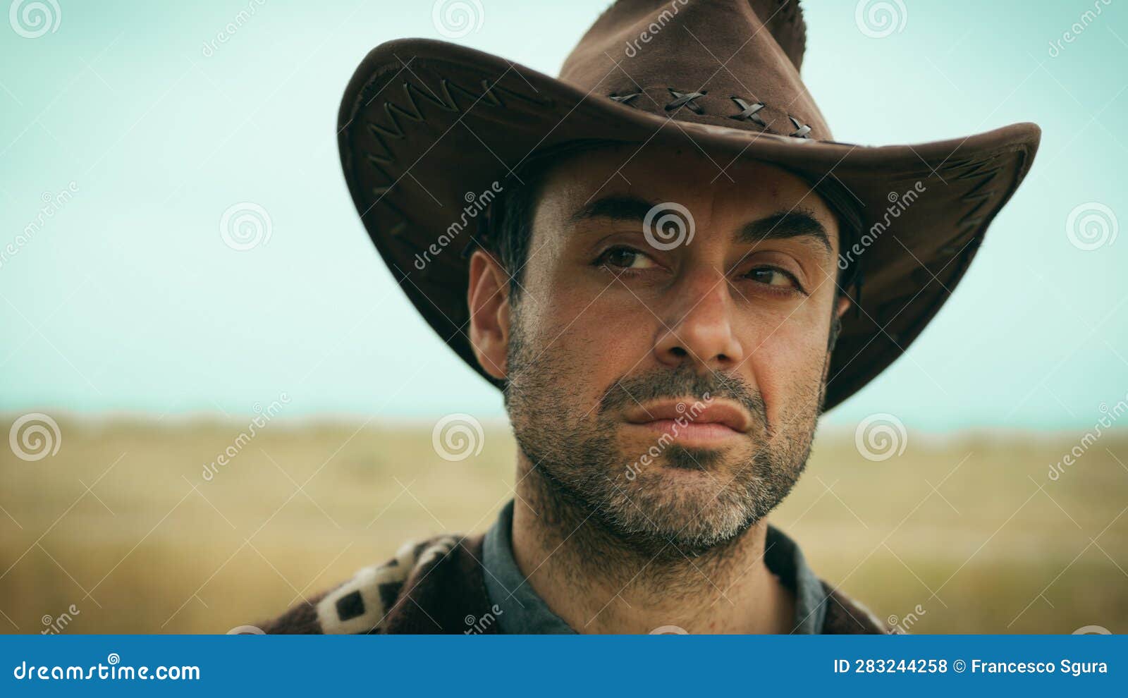 Cowboy with defiant look. stock photo. Image of west - 283244258