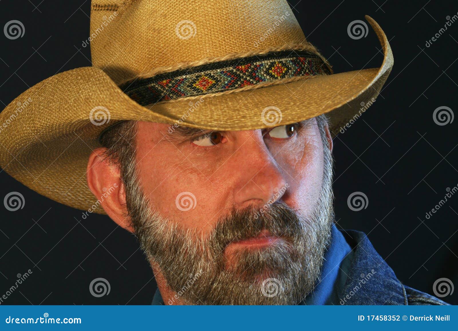 A Cowboy Glances Over His Shoulder Stock Photo - Image of blue, cowboys ...