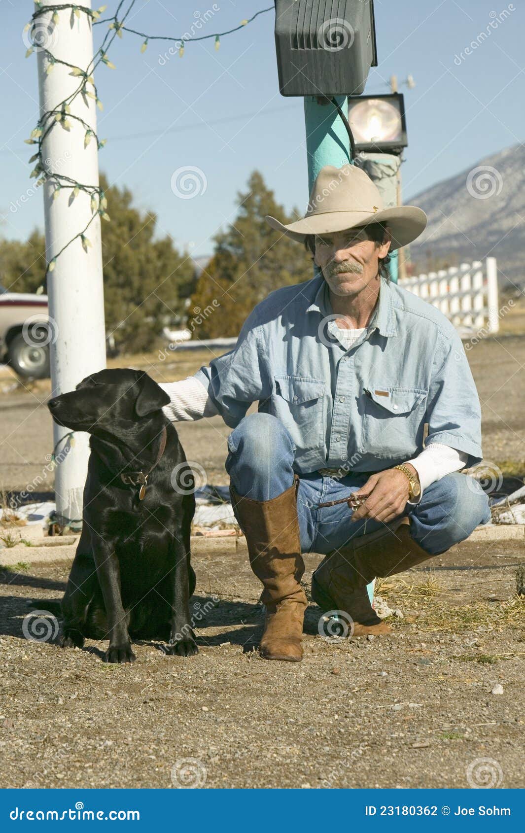 Cowboy with his dog editorial photography. Image of aged - 23180362