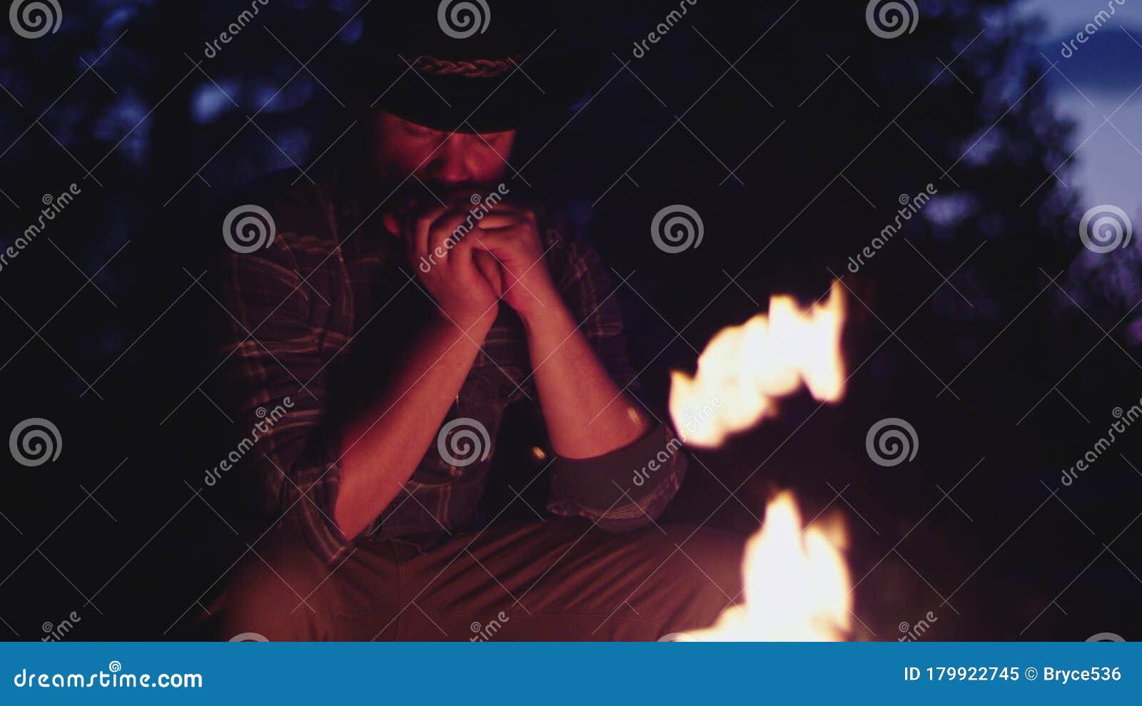 Cowboy Plays the Harmonica by a Campfire at Night in Slow Motion Stock ...