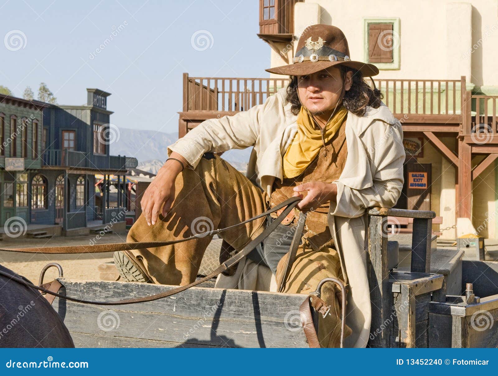 Cowboy sitting on a wagon stock photo. Image of hollywood - 13452240