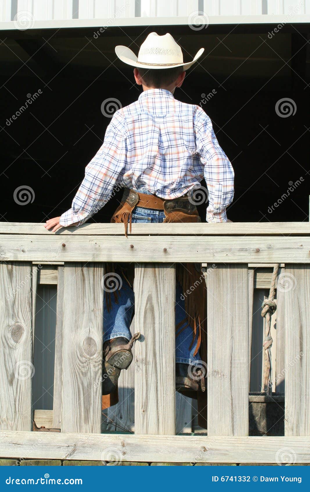 Cowboy Sitting on Wooden Fence Stock Photo - Image of clothed, sitting ...