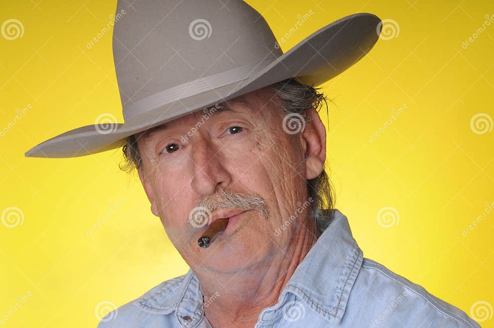 Cowboy smoking a Cigar stock photo. Image of countryman - 15315818