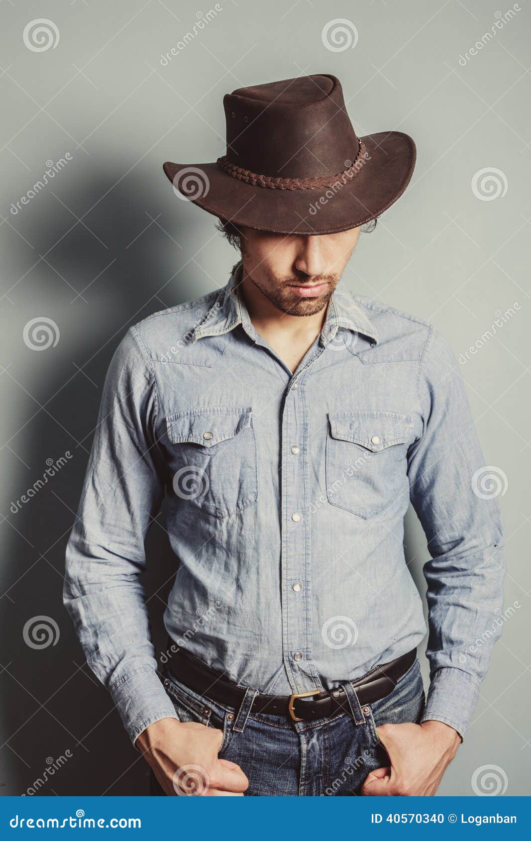 Cowboy Standing by a Blue Wall Stock Photo - Image of happy, studio ...
