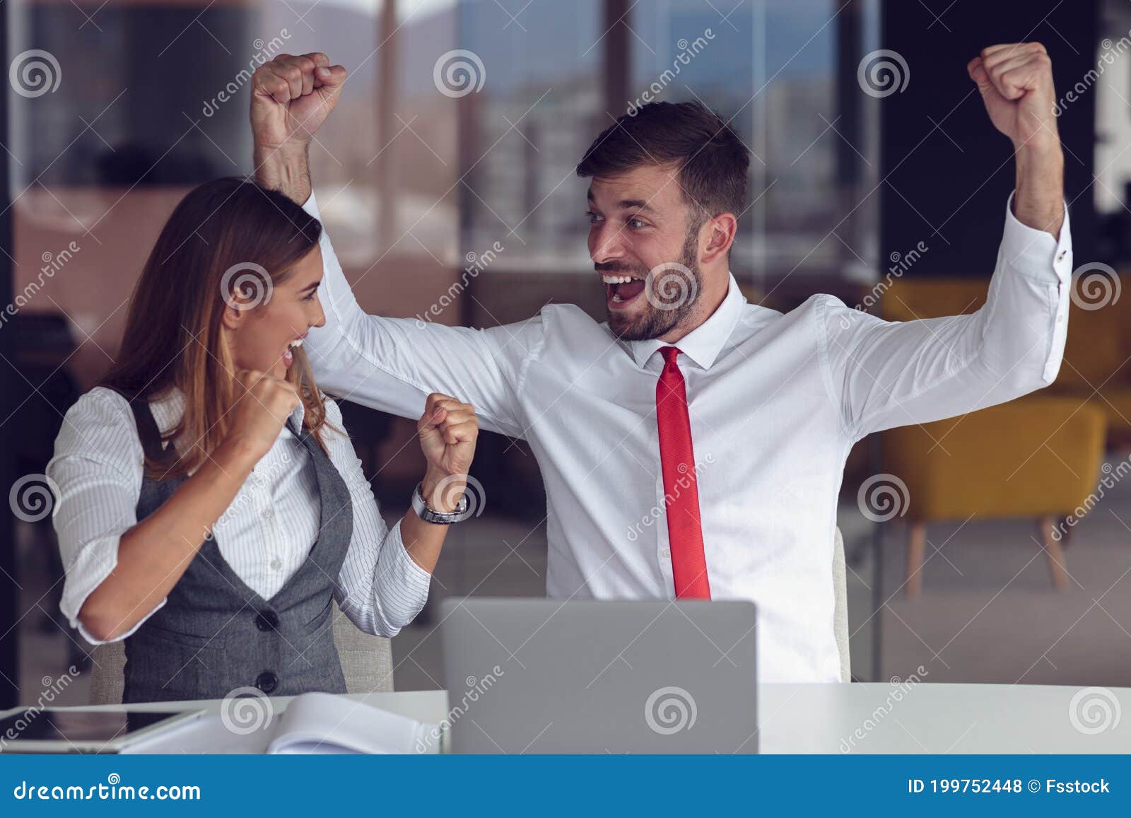 Coworkers Celebrating Success in Modern Office Using Laptop Computer ...