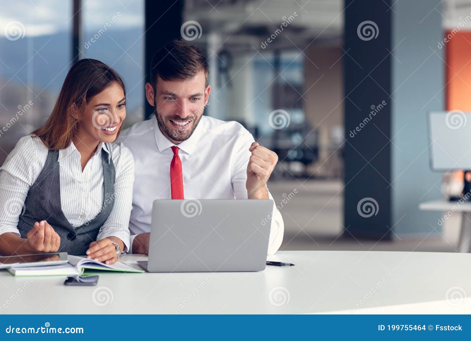 Coworkers Celebrating Success in Modern Office Using Laptop Computer ...