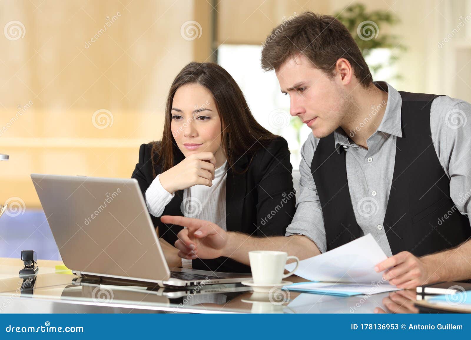 Coworkers Checking Laptop Content Together at Office Stock Image ...