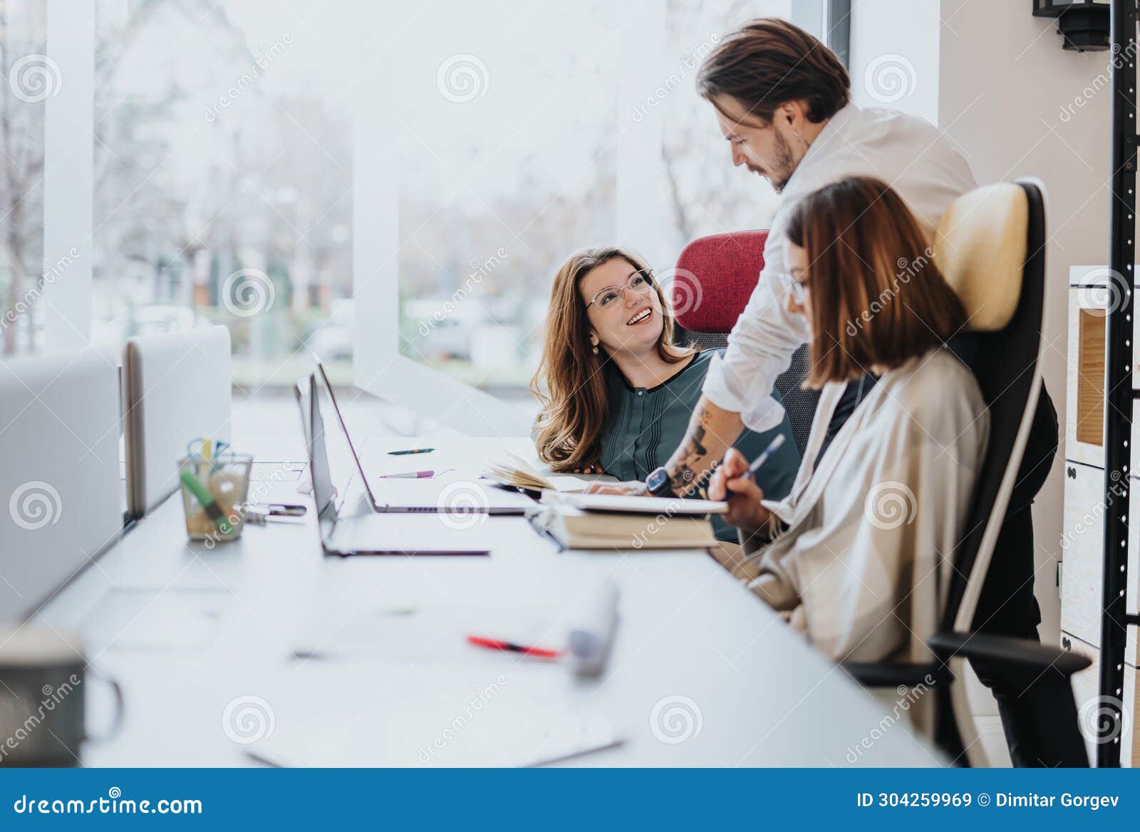 Young Employees Collaborating in a Modern Office. Discussing Project ...