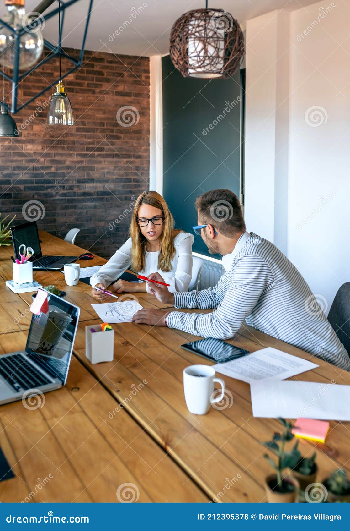 Coworkers Discussing Project in the Office Stock Photo - Image of ...