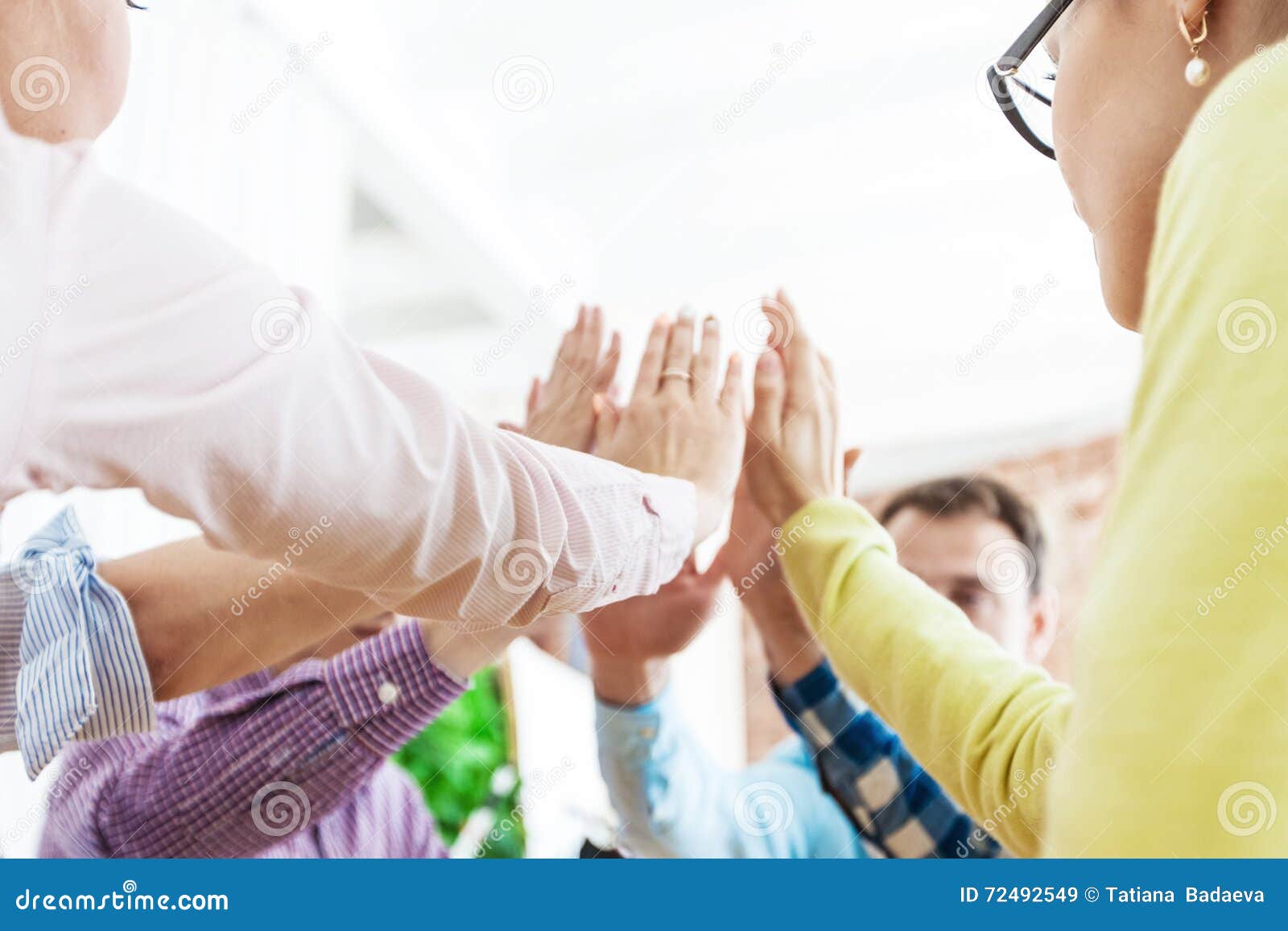 Coworkers doing high five stock image. Image of startup - 72492549
