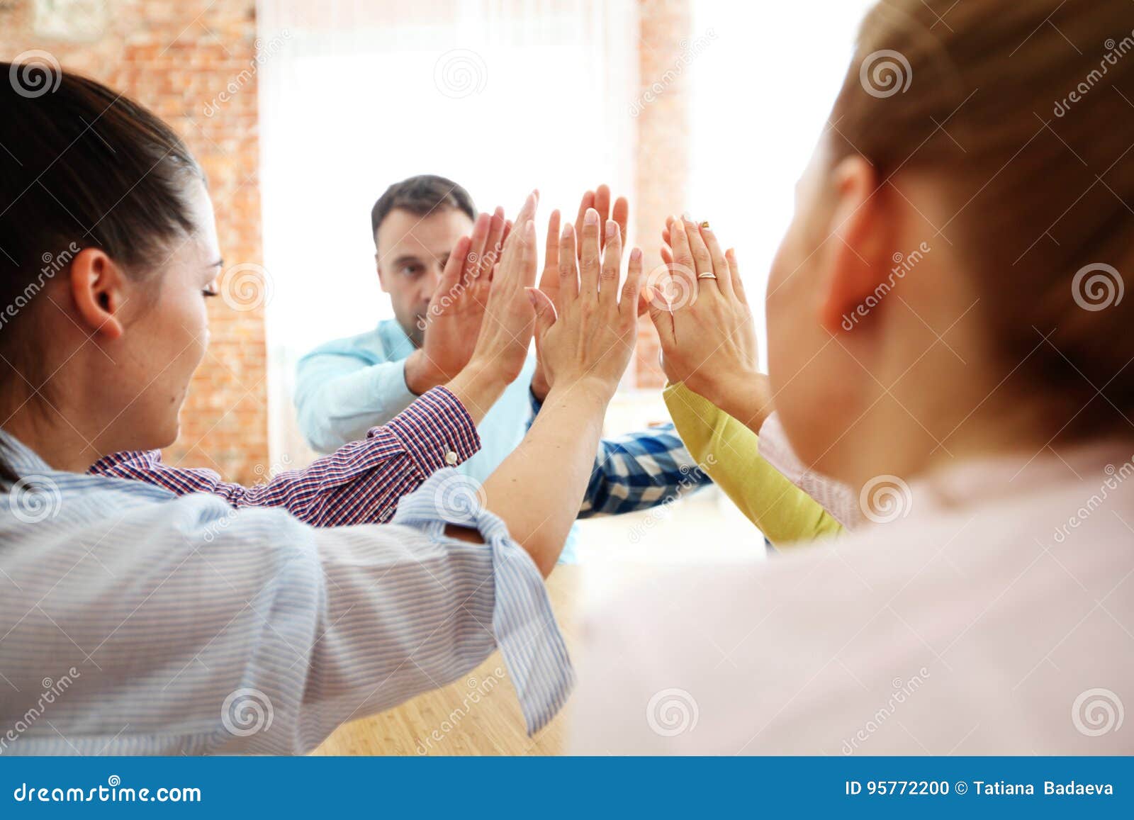 Coworkers doing high five stock photo. Image of give - 95772200