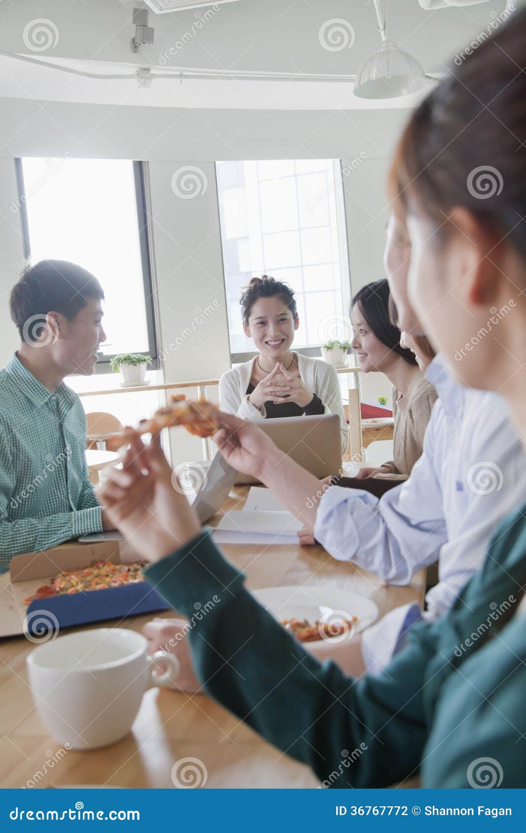 Coworkers Eating and Working in the Cafeteria Stock Photo - Image of ...