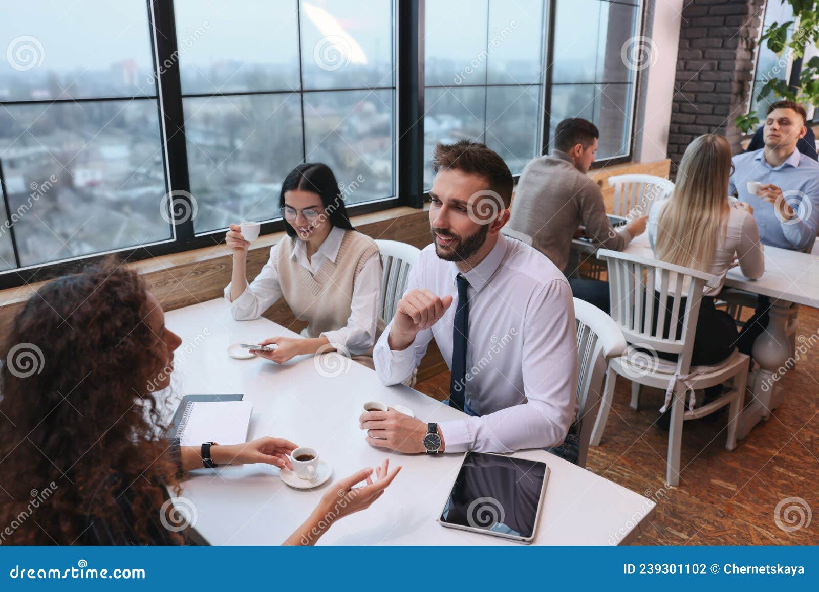 Coworkers Having Coffee Break Near Window Stock Photo - Image of ...