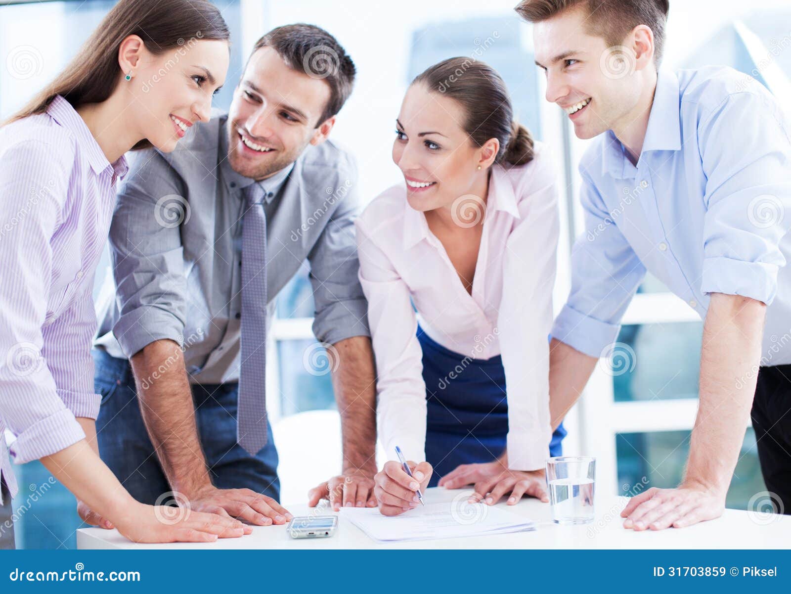 Coworkers Leaning Over Table Stock Image - Image of staff, business ...