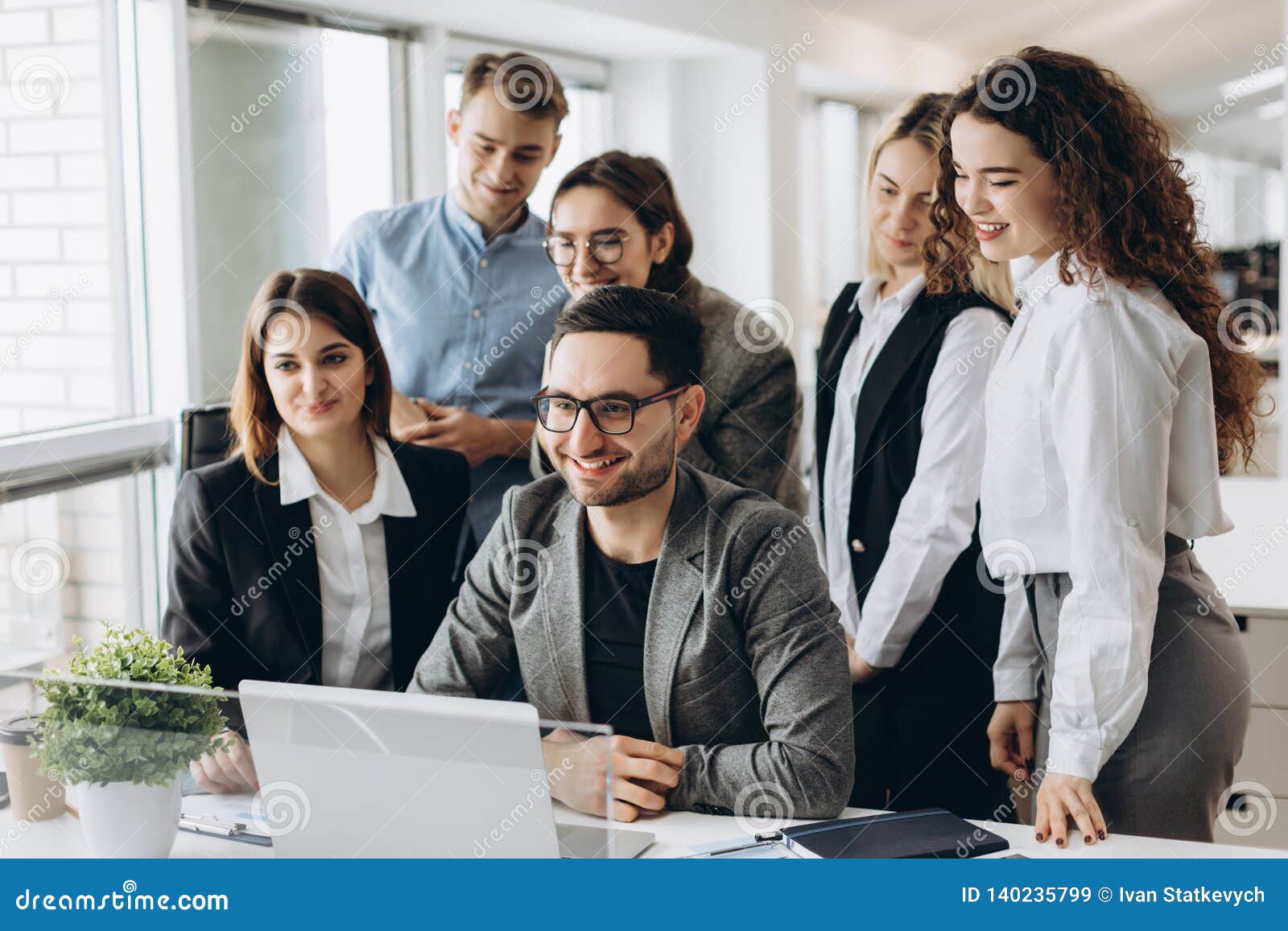 Coworkers Looking at a Computer and Talking about Work Stock Image ...