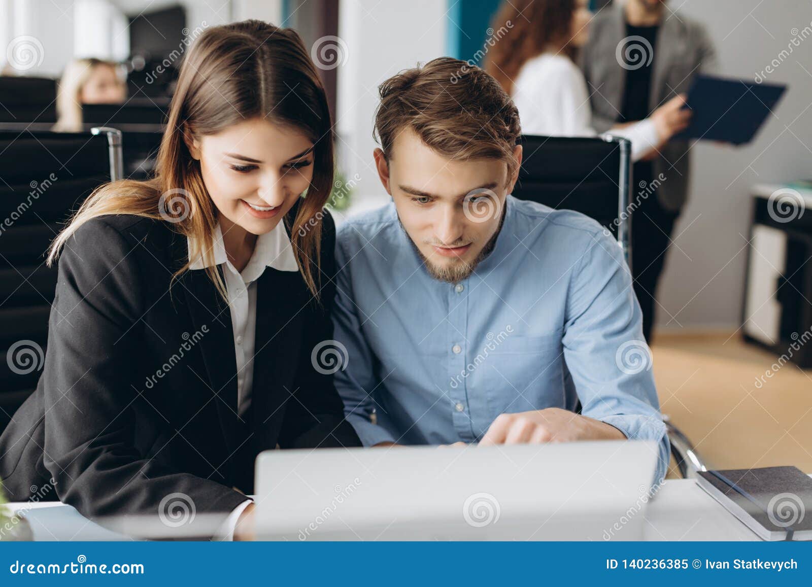Coworkers Looking at a Computer and Talking about Work Stock Image ...