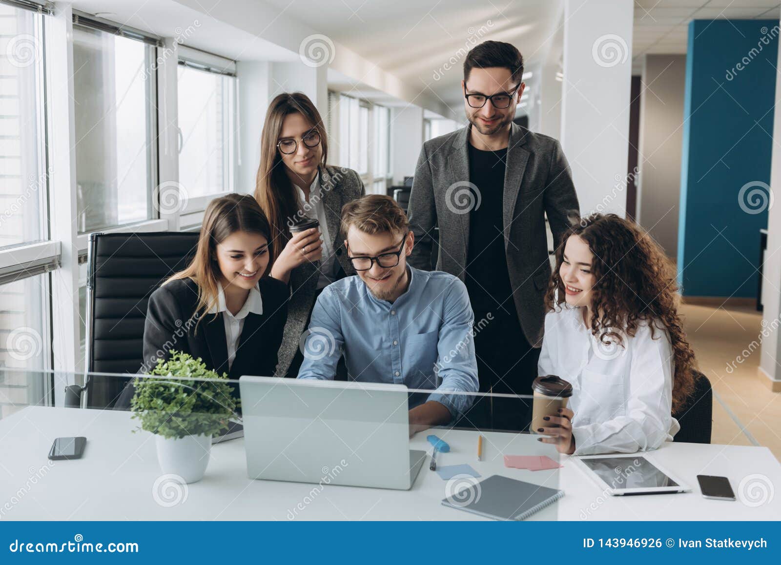 Coworkers Looking at a Computer and Talking about Work Stock Photo ...