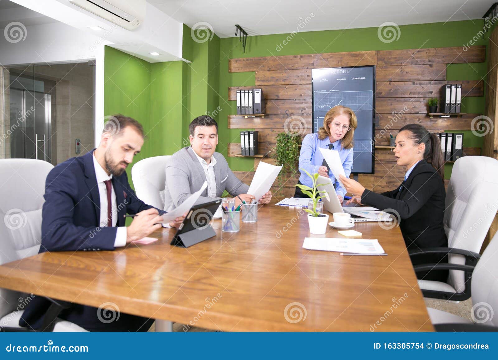 Coworkers Looking at a Computer and Talking about Work Stock Photo ...