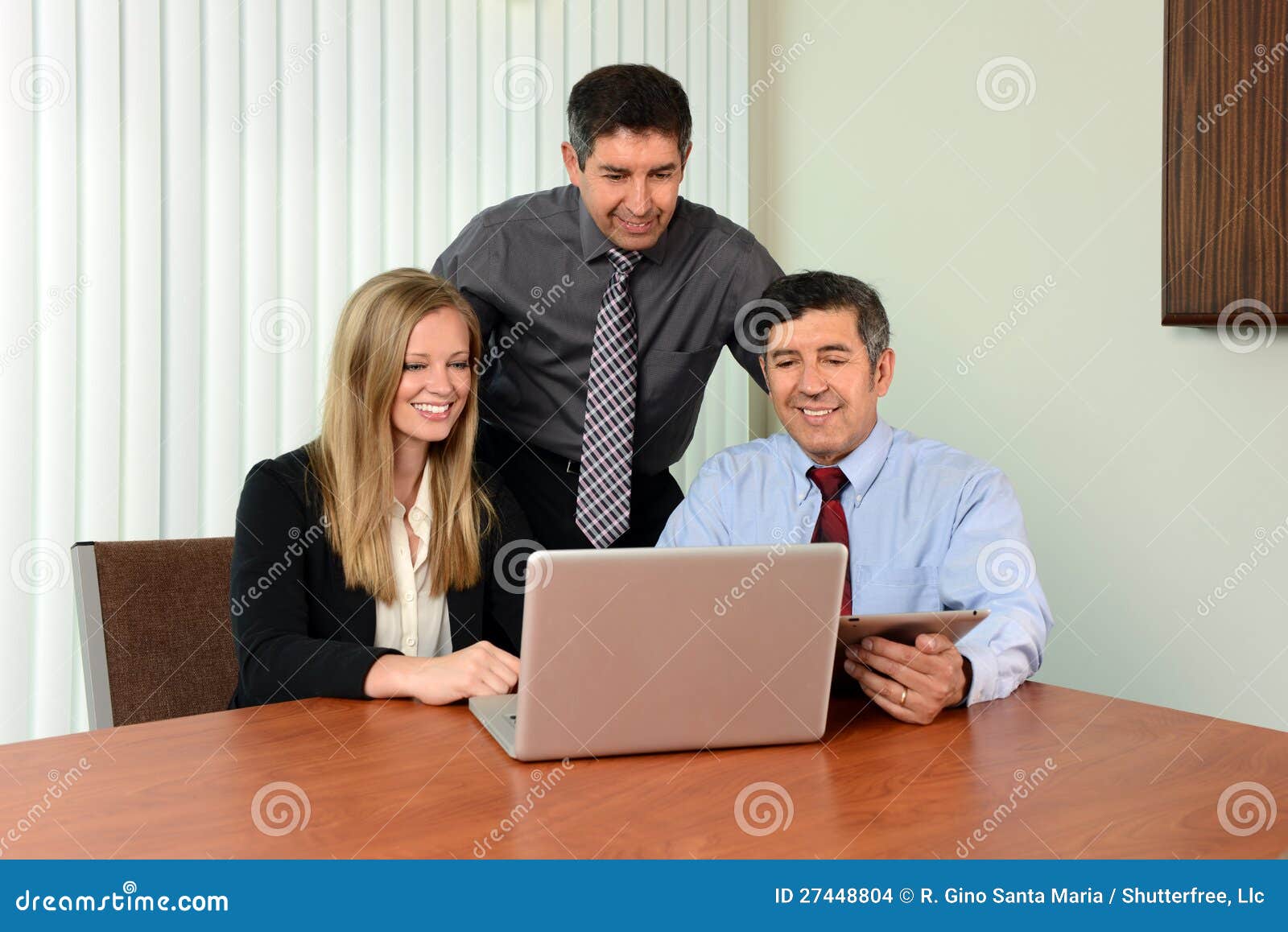 Coworkers Sharing Information on Laptop Stock Photo - Image of indoors ...
