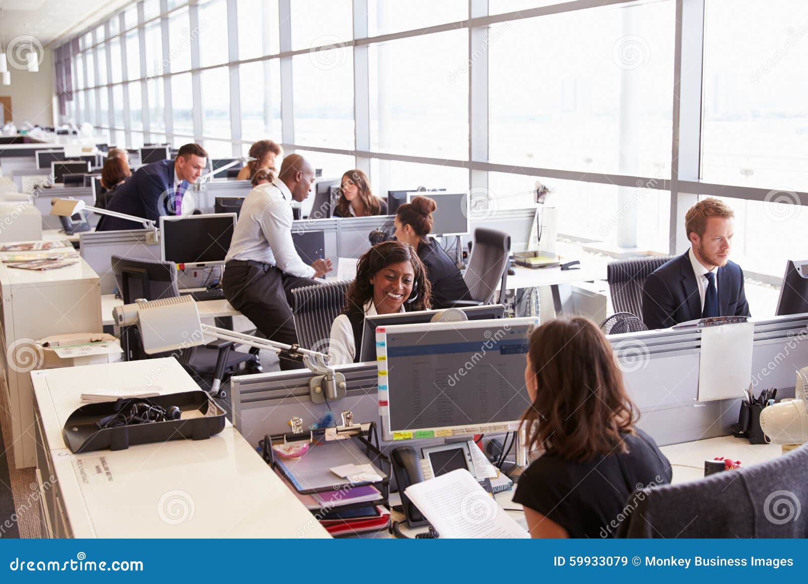 Coworkers At Their Desks In A Busy, Open Plan Office Stock Image ...