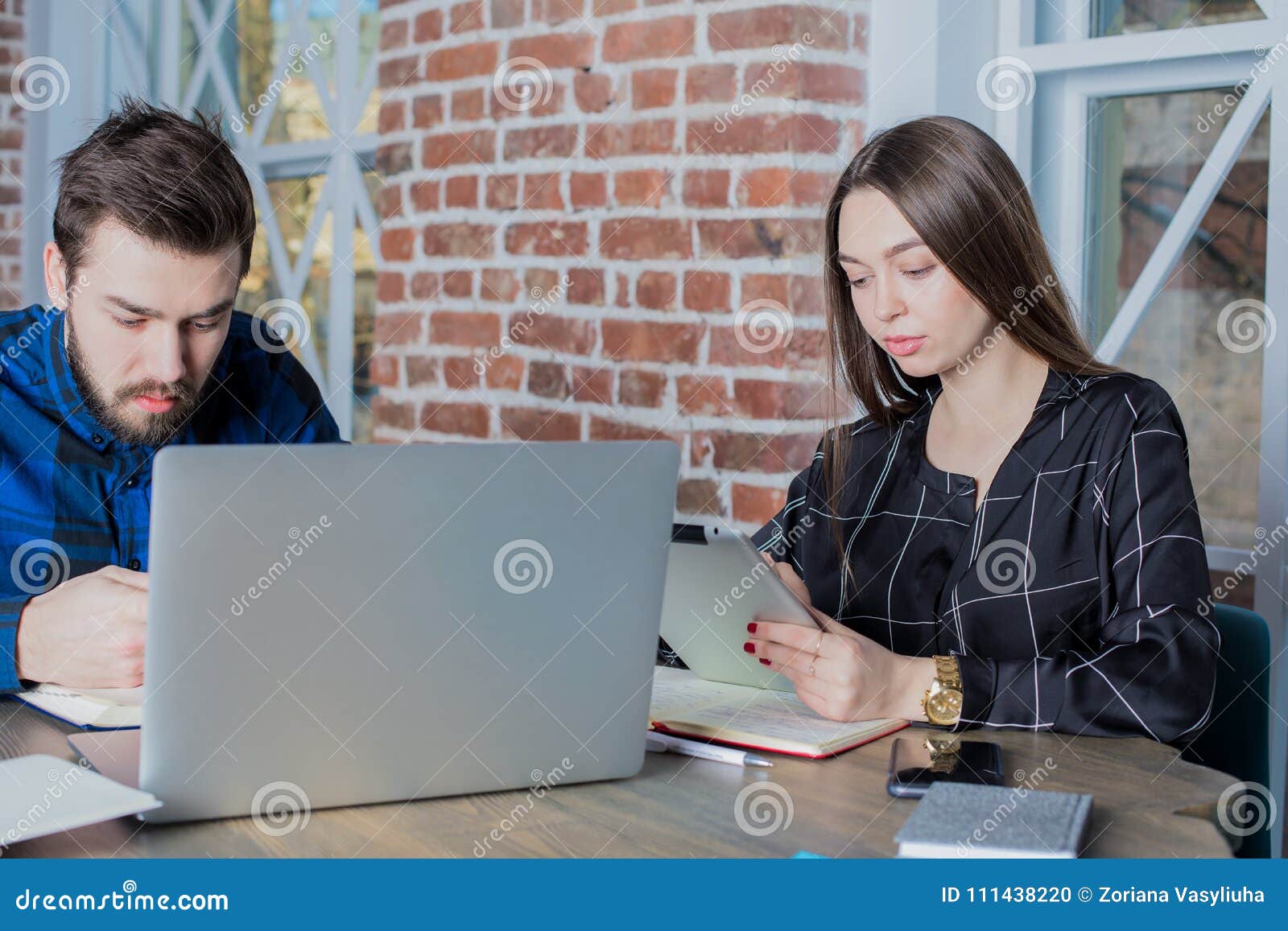 Coworkers Working Together Using Net-book and Digital Tablet ...