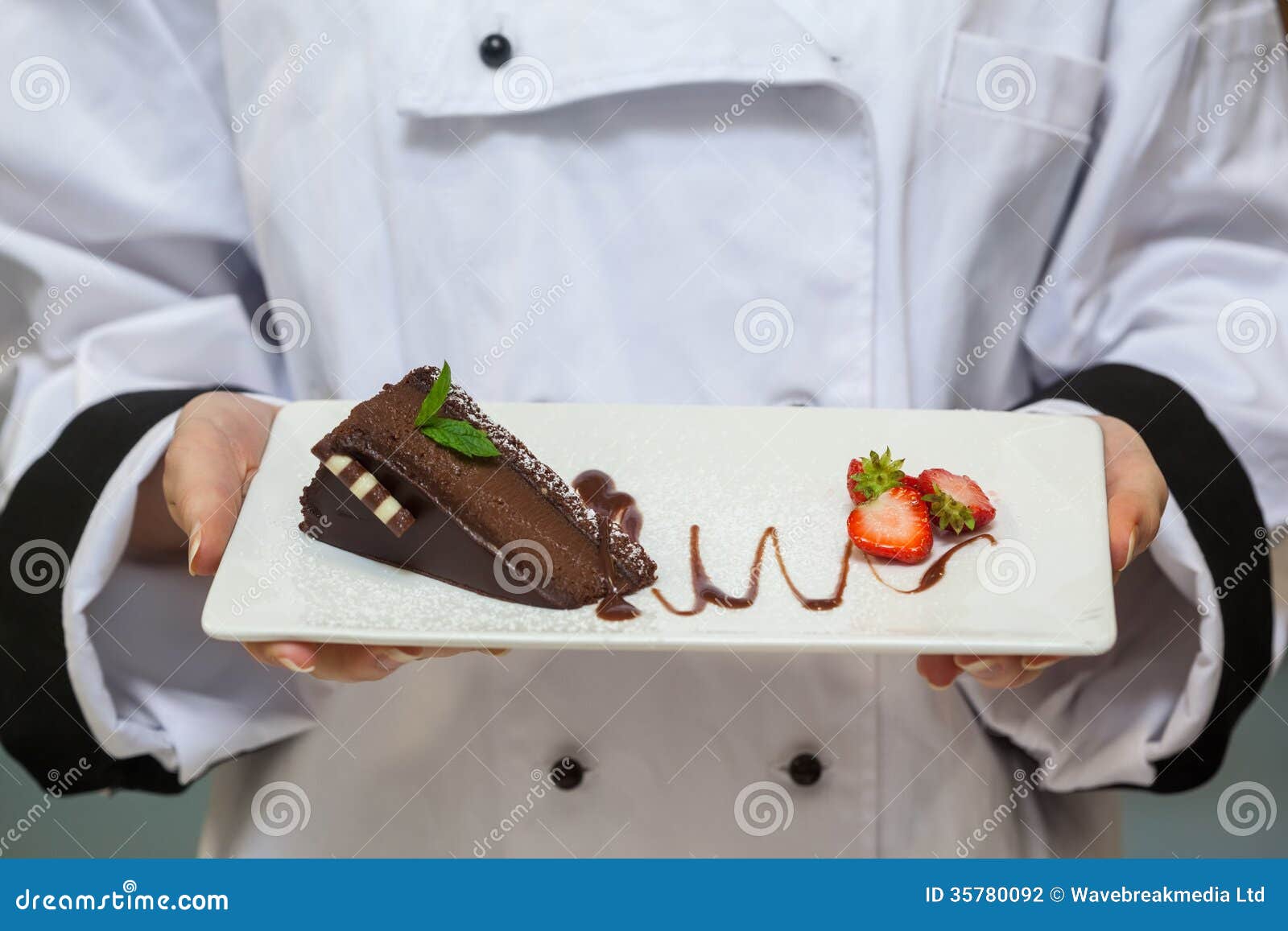 Cozinheiro Chefe Que Apresenta O Bolo De Chocolate Com Morangos Foto de ...