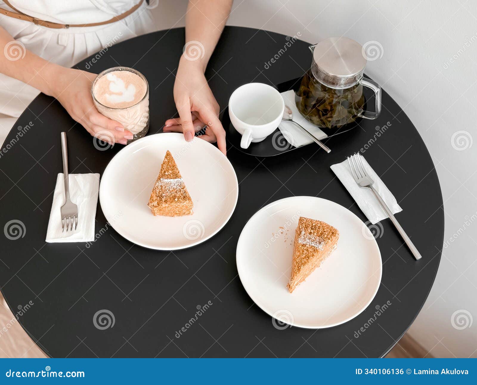 Cozy Cafe Setting with Tea and Cake Slices on a Round Table Stock Photo ...