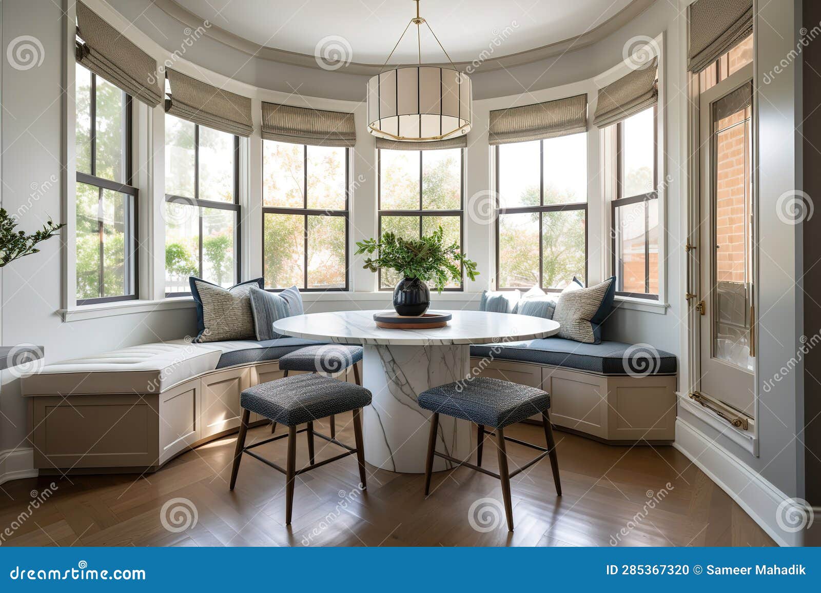 A Cozy and Inviting Breakfast Nook with a Round Table and Comfortable ...