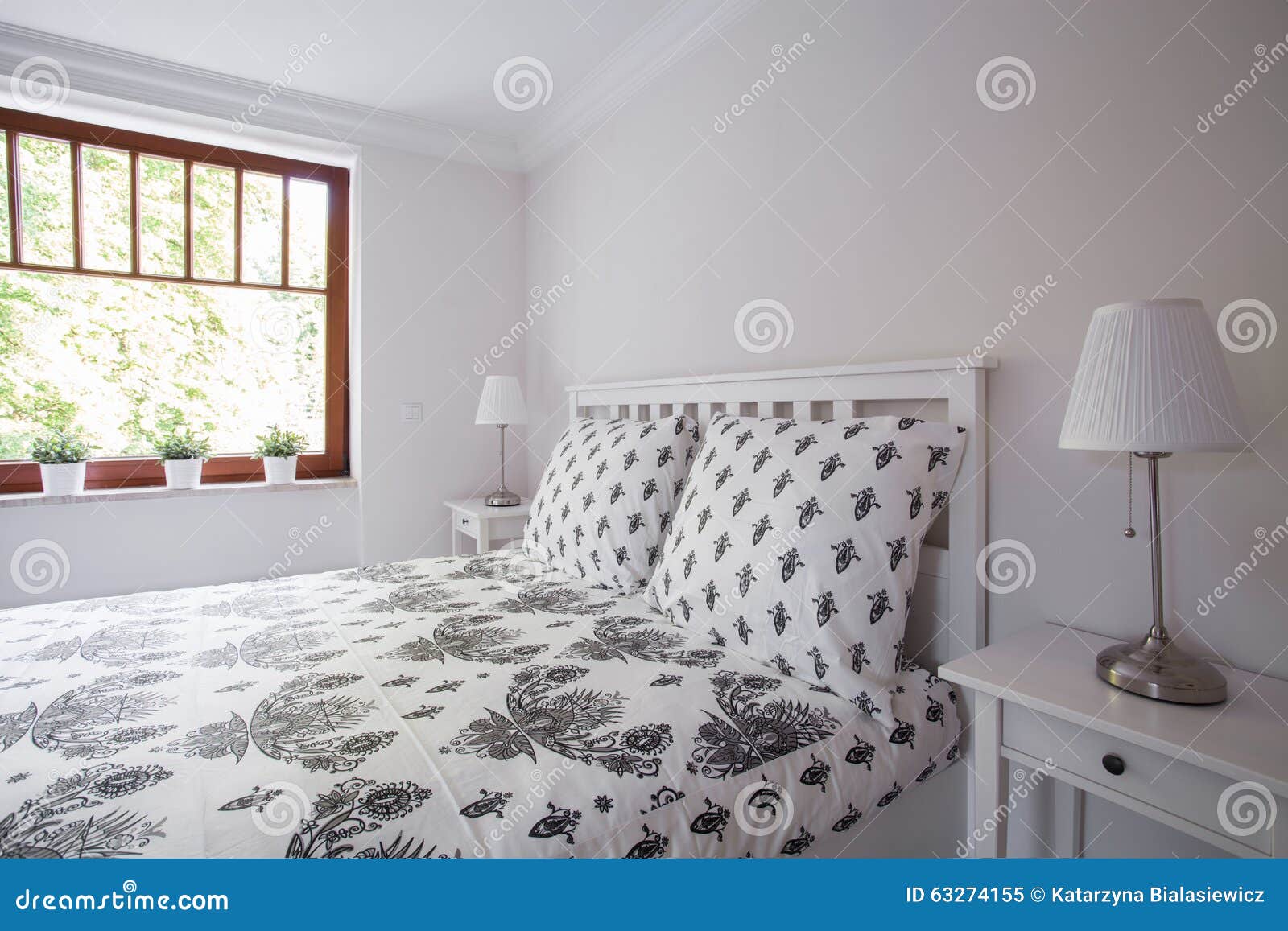 Cozy and neat bed stock image. Image of lamp, bedding - 63274155