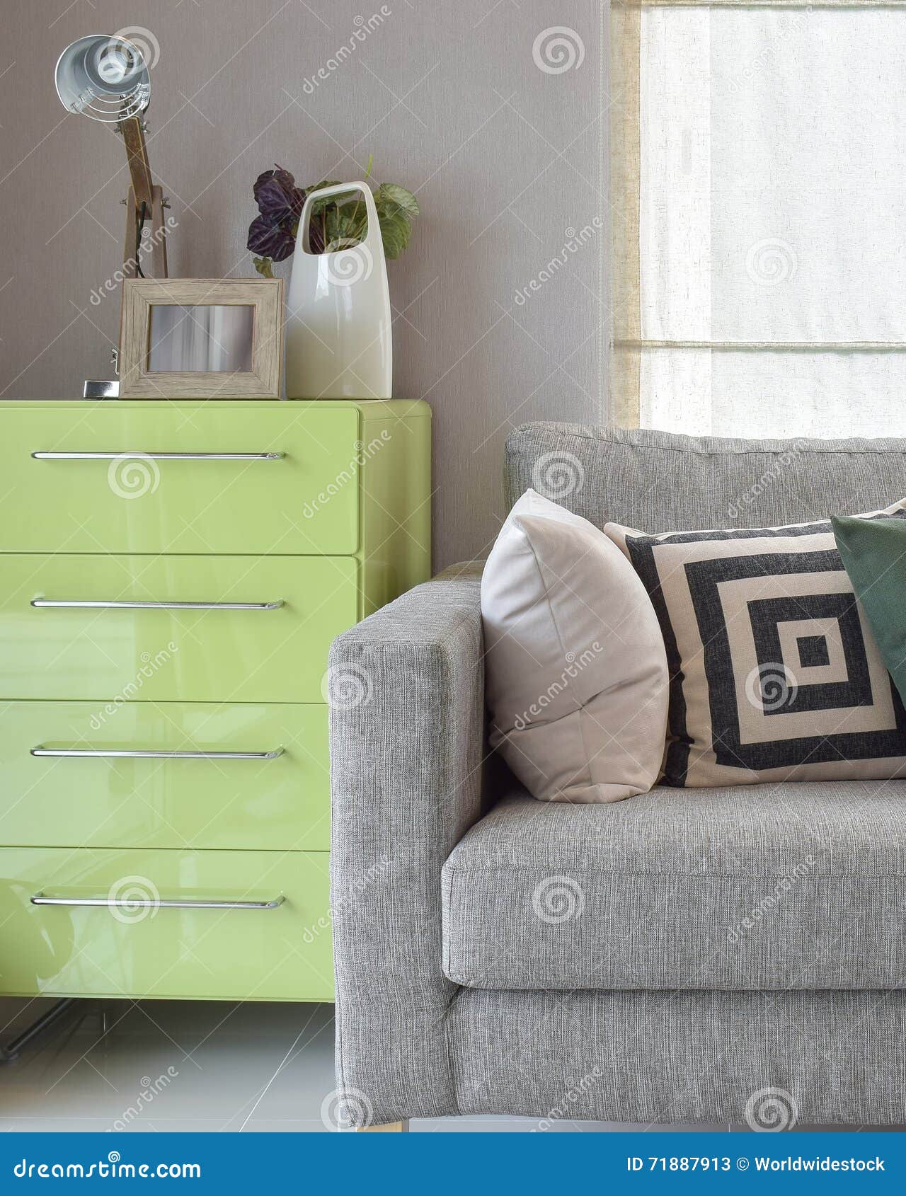 Cozy Sofa with Geometric Pattern Pillows and Green Sideboard in Stock ...