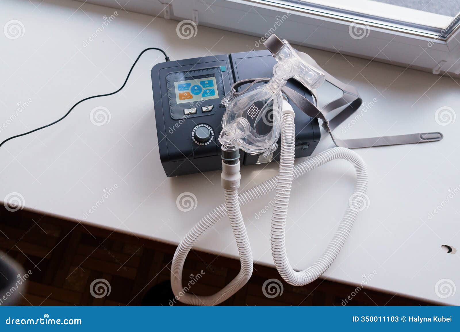 CPAP Machine for Sleep Apnea Treatment with Hose and Mask on a Table ...