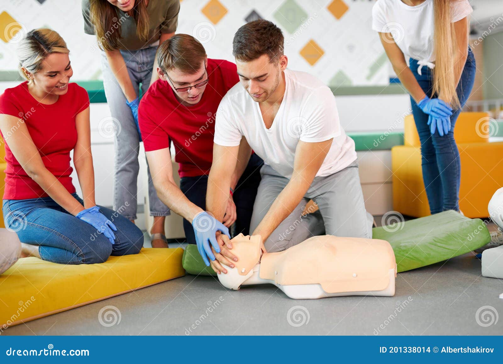 CPR Class with Caucasian Instructors Speaking and Demonstrating Help ...