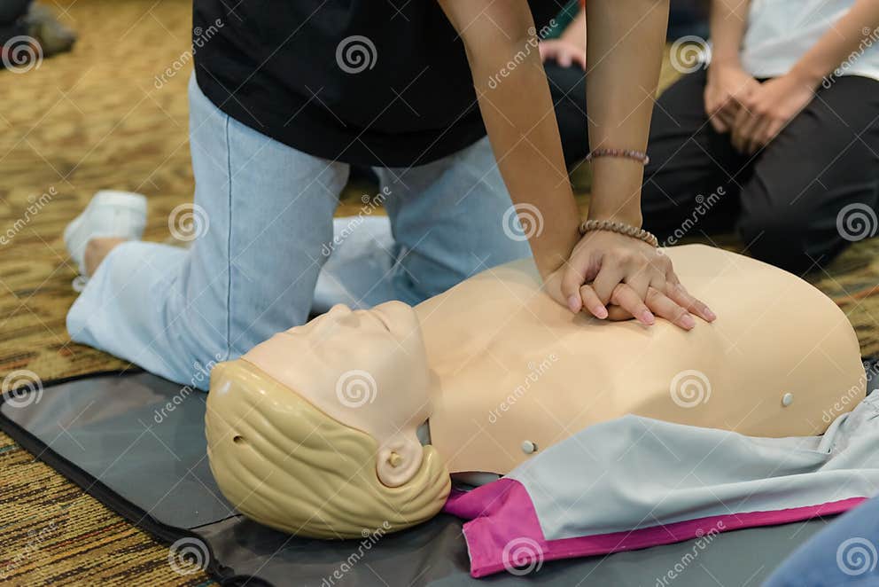 CPR First Aid Training with CPR Dummy in the Class. Demonstrating Chest ...
