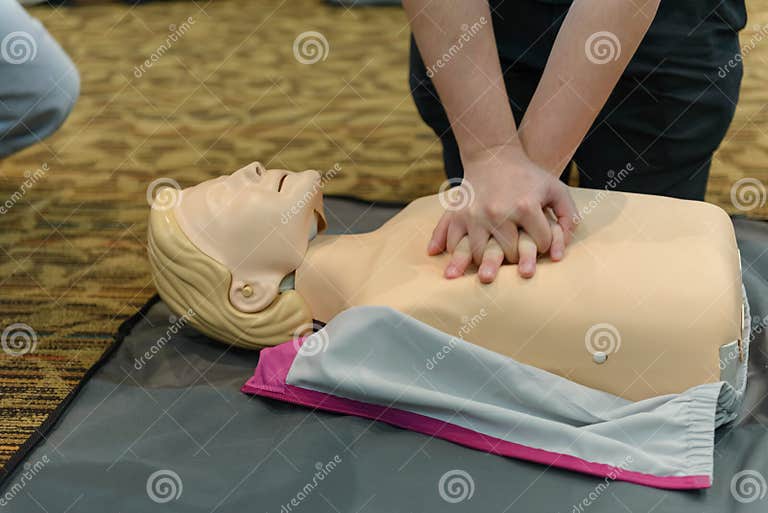 CPR First Aid Training with CPR Dummy in the Class. Demonstrating Chest ...