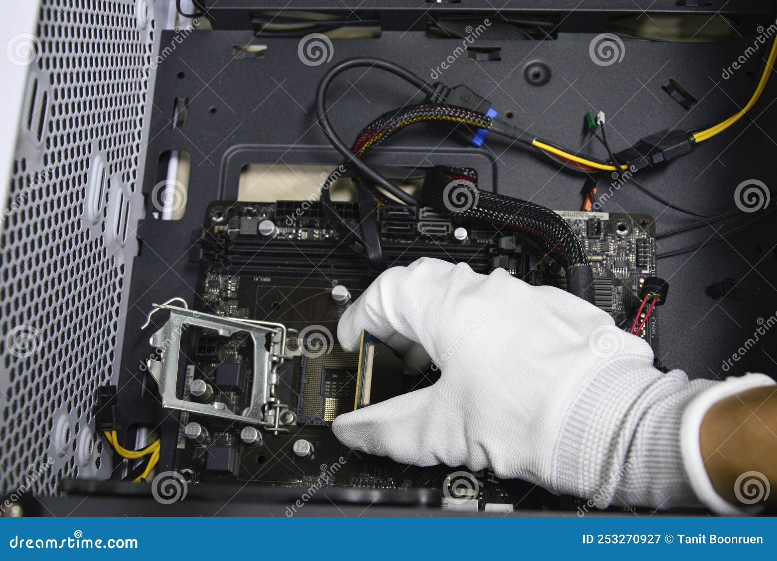 Image of a Technician Inserting a CPU Chip Onto a Computer Motherboard ...