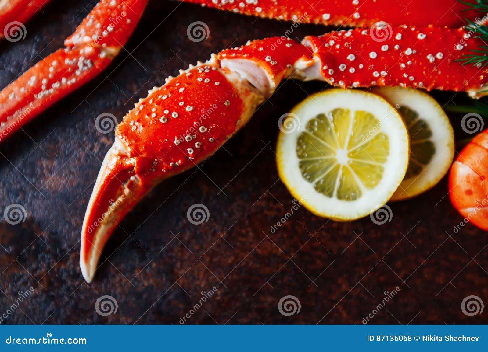 Crab Claw with Lemon Close Up on a Dark Background Stock Photo - Image ...