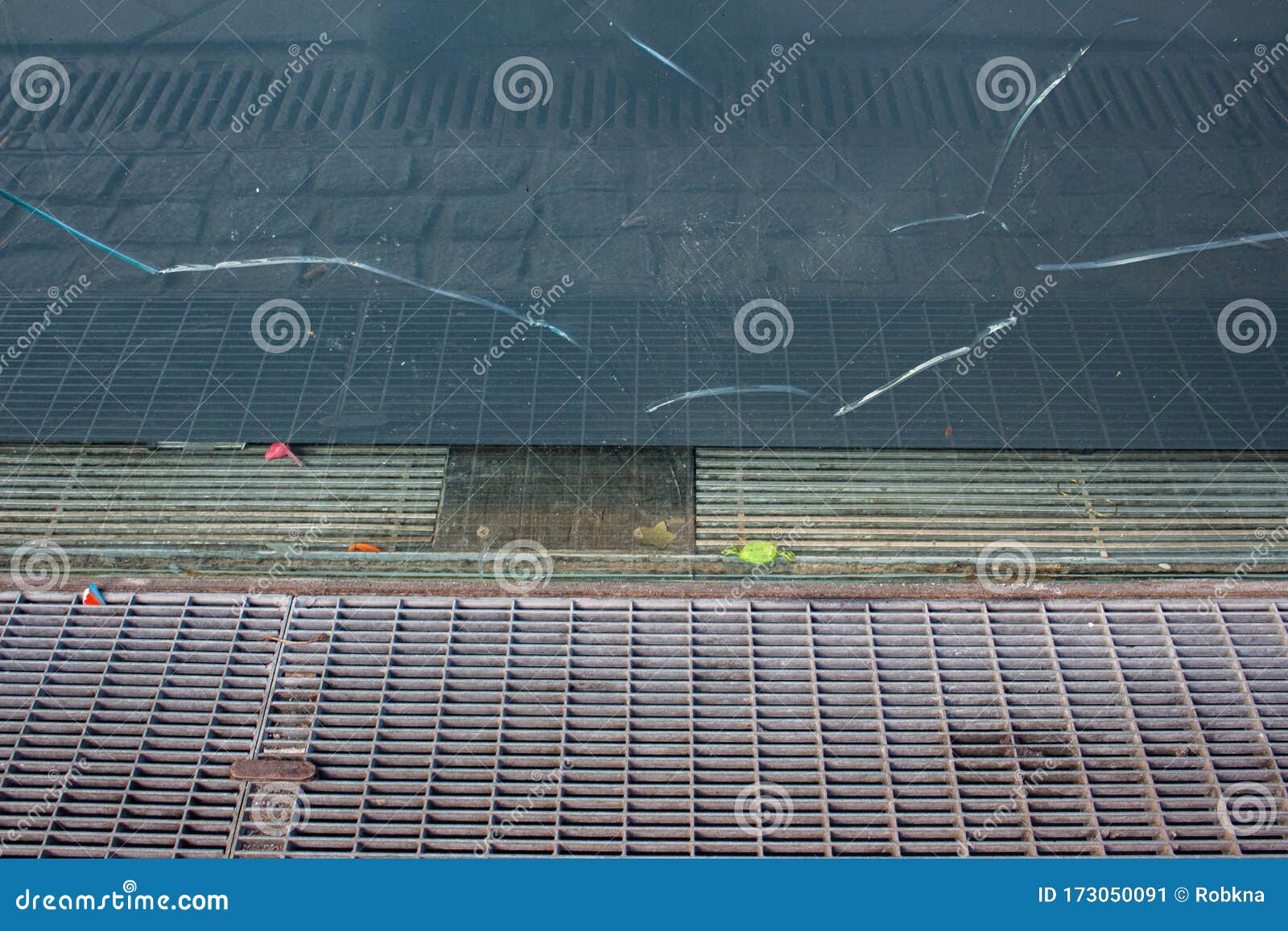 Crack in a Broken Store Window and a Reflection of a Metal Grille Stock ...