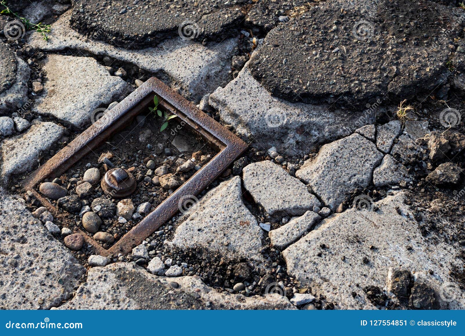 Cracked Broken Distressed Pavement with Broken Utility Hook Up Stock ...