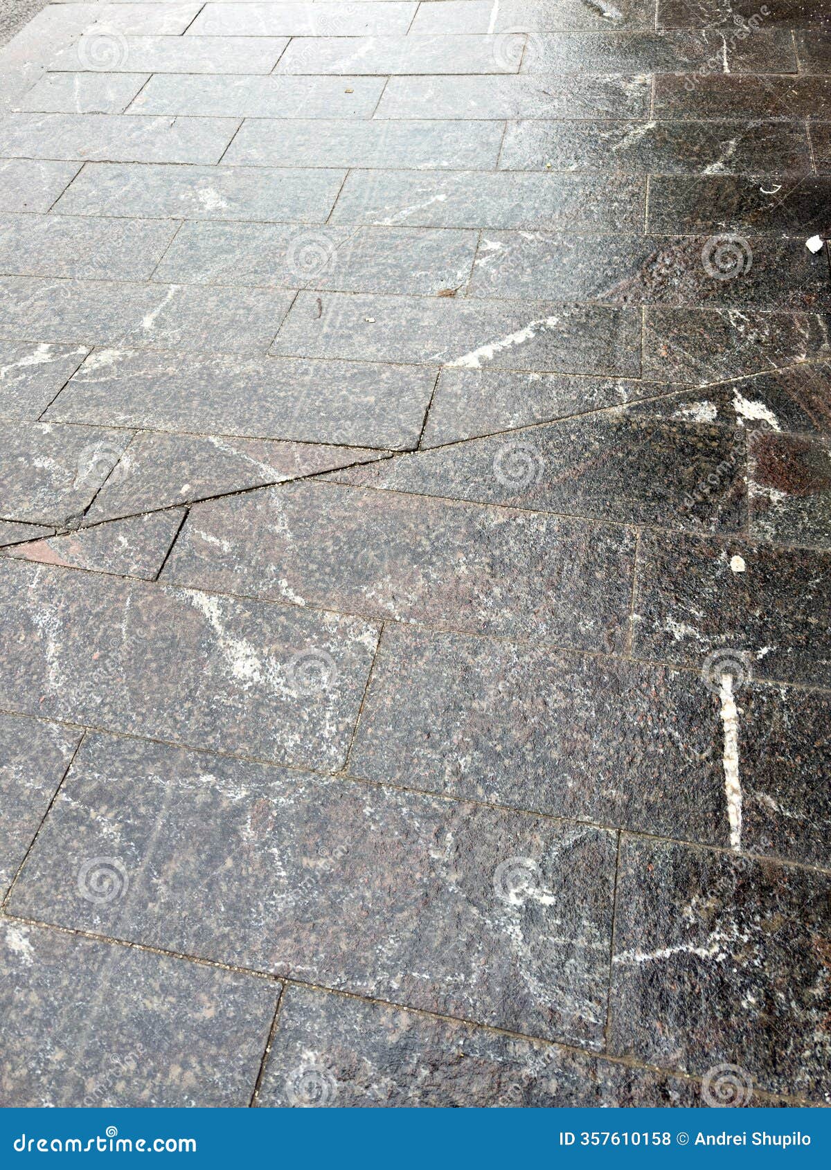 A Cracked and Broken Tile Floor with a Wet Surface Stock Photo - Image ...