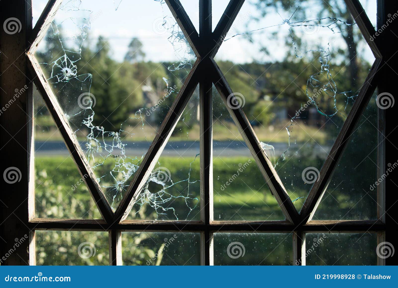 Cracked and Broken Window Glass Punched by a Pistol Bullet Stock Photo ...