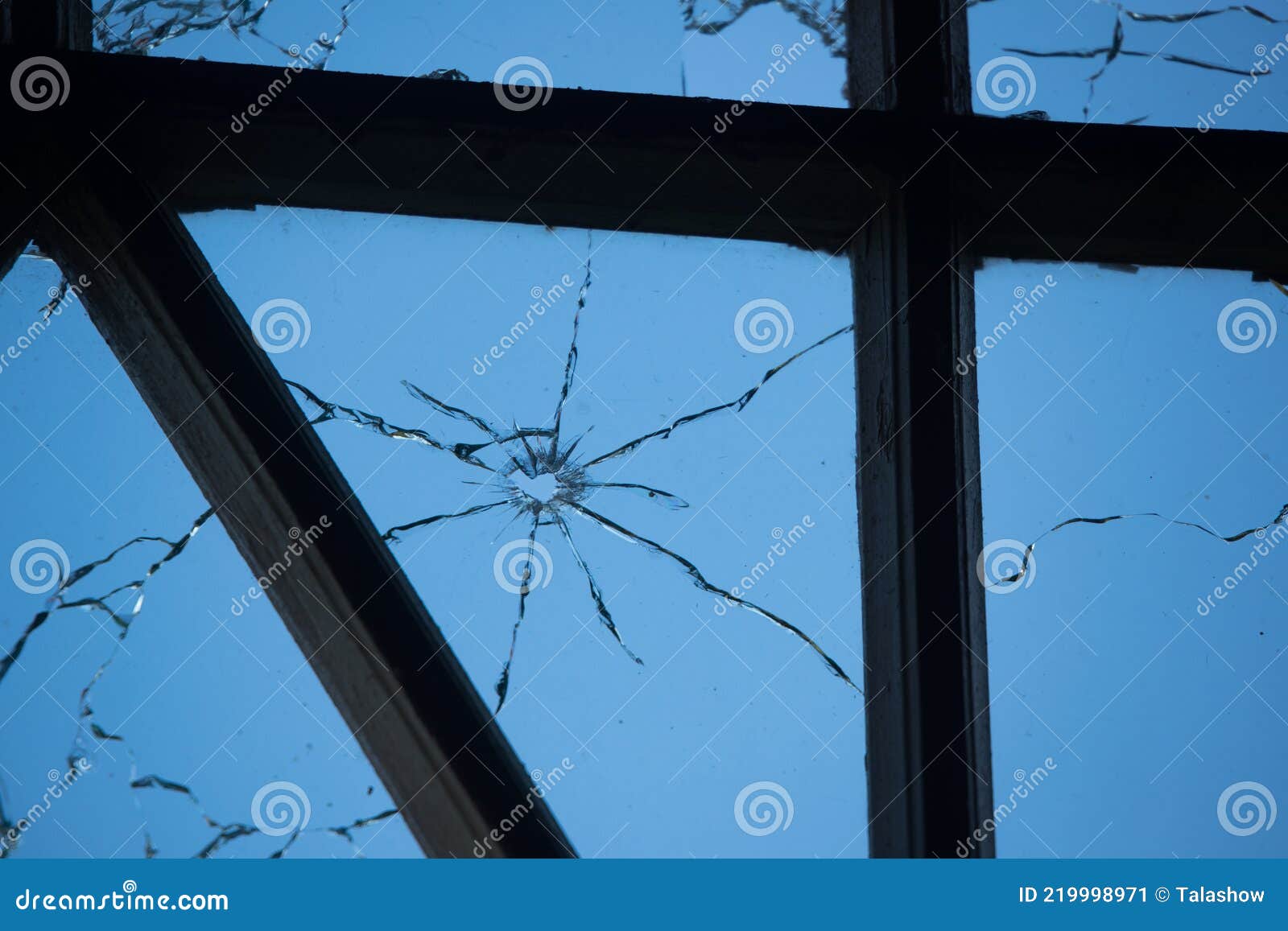 Cracked and Broken Window Glass Punched by a Pistol Bullet Stock Image ...