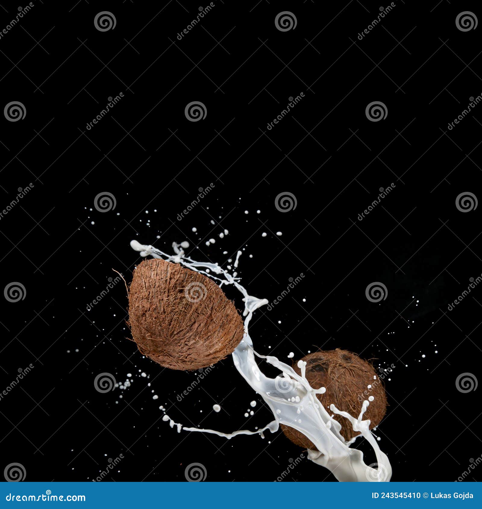 Cracked Coconut with Milk Splash Flying in the Air. Stock Photo - Image ...