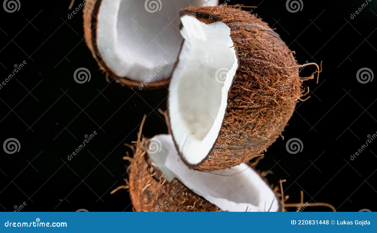 Cracked Coconuts Falling Down on Black Background. Stock Photo - Image ...