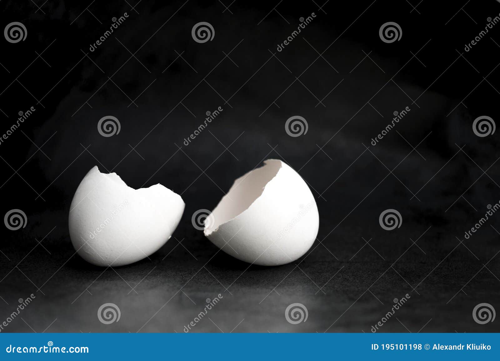 Cracked Eggshell on a Black Background. Broken Egg in Half. Stock Photo ...