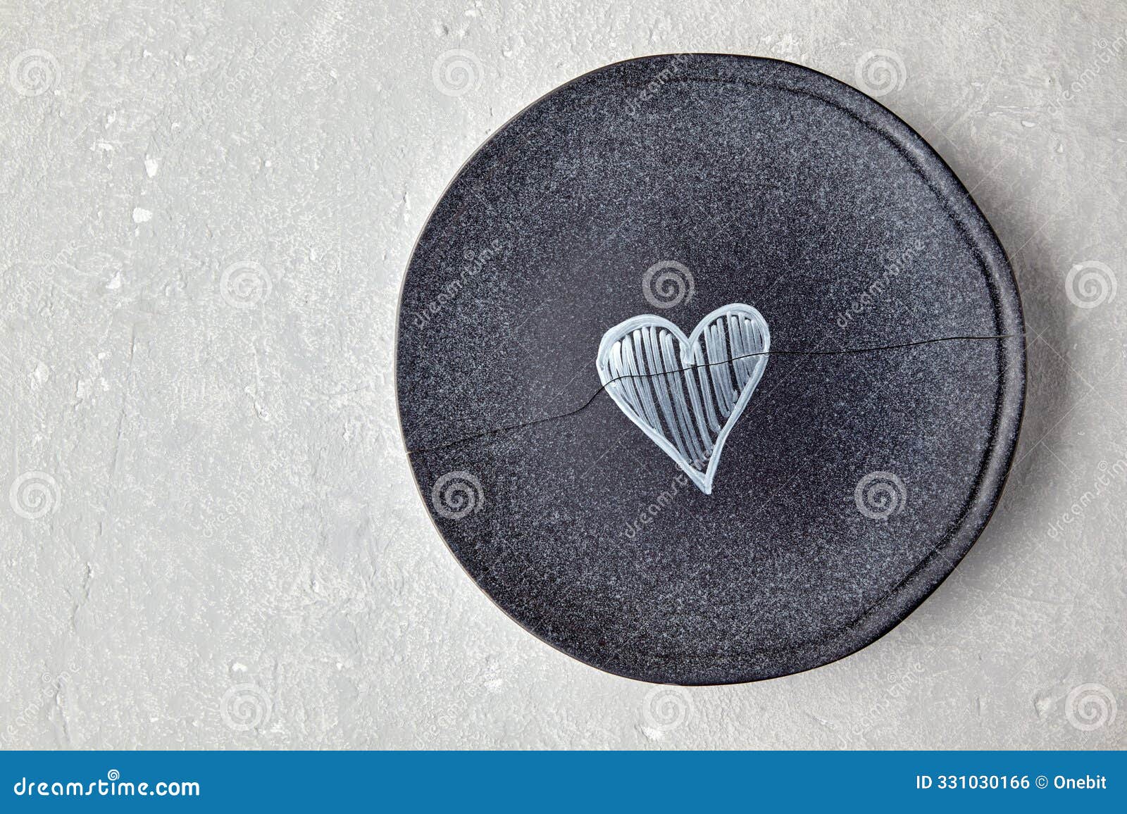 Cracked Gray Ceramic Plate with Painted White Heart on Stone Table. Top ...