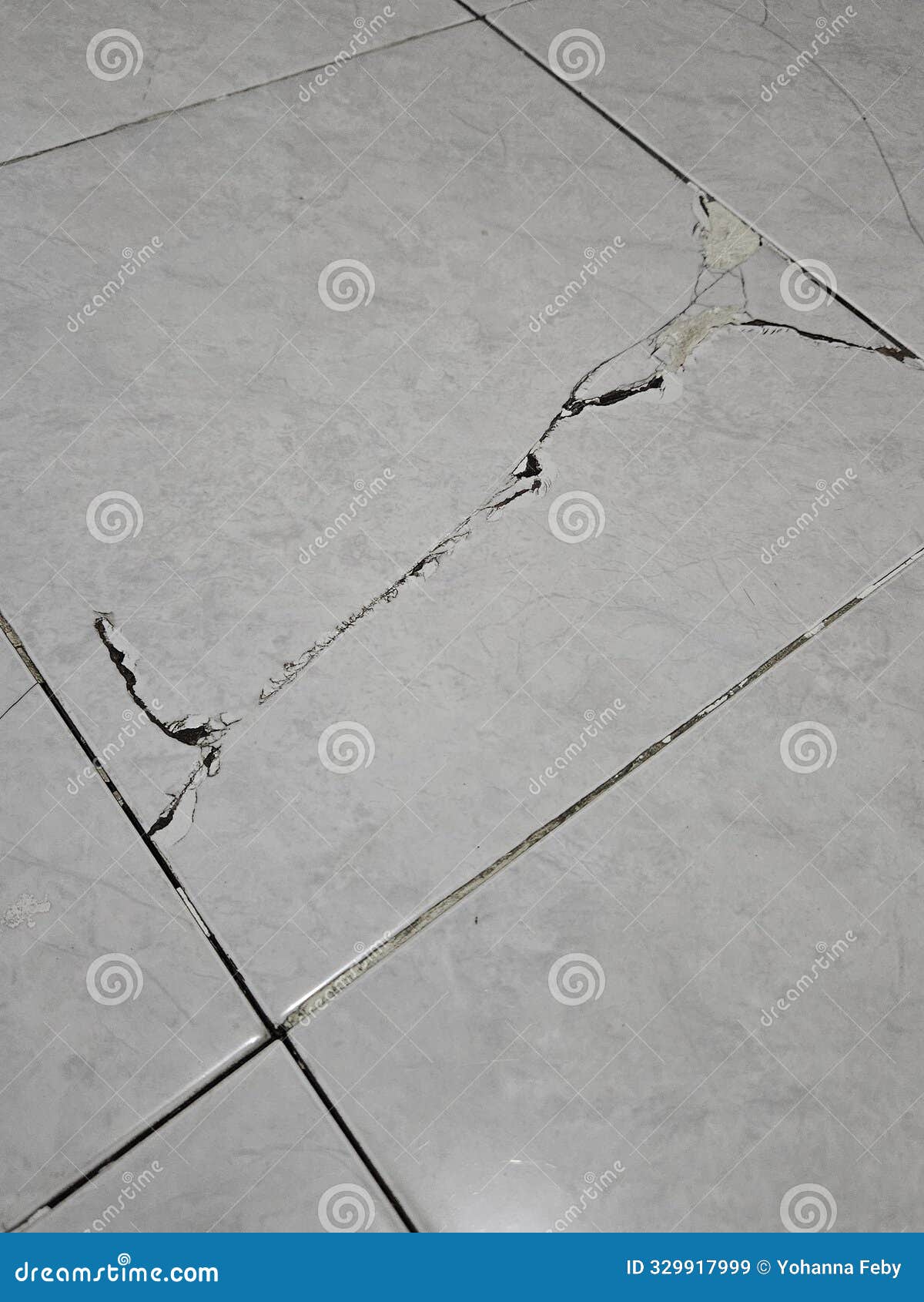 Cracked tile on the floor. stock image. Image of building - 329917999