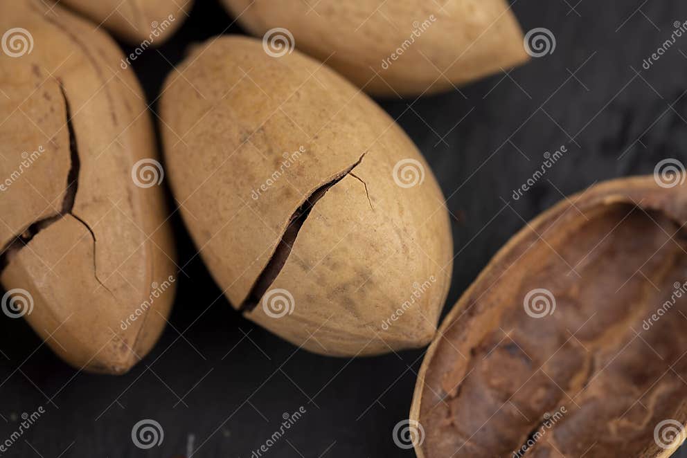 Cracked Unpeeled Pecans Close-up on the Table Stock Photo - Image of ...